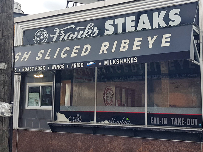 The iconic Frank's Steaks storefront beckons like a beacon of hope for the cheesesteak-deprived. That "FRESH SLICED RIBEYE" promise isn't just signage&mdash;it's a solemn vow.