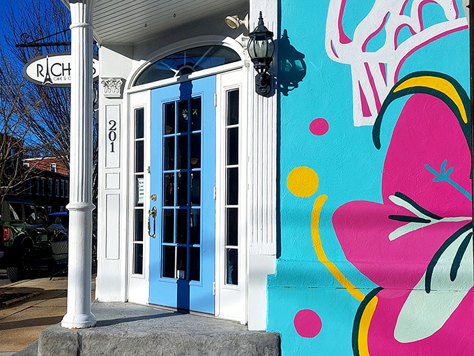 That iconic blue door isn't just an entrance&mdash;it's a portal to crepe paradise. The vibrant mural beside it hints at the colorful culinary adventure waiting inside.