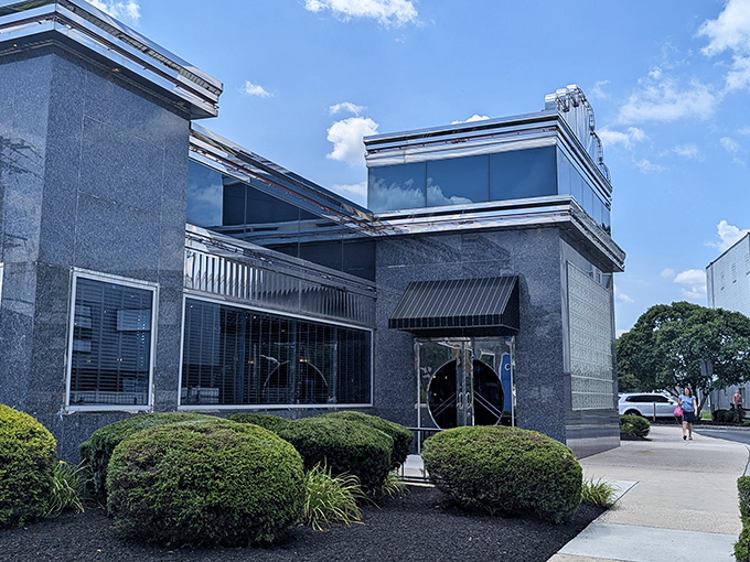 The gleaming blue-gray exterior of Collegeville Diner stands like a time capsule with modern flair, beckoning hungry travelers with its classic silhouette against Pennsylvania skies.