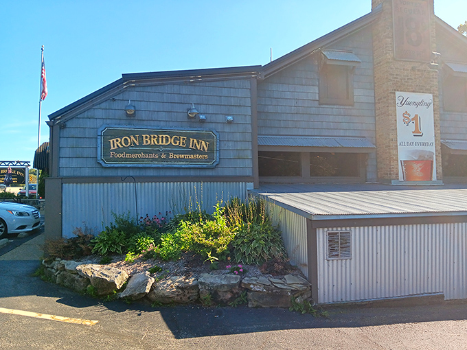 The Iron Bridge Inn stands proudly in Mercer, its rustic exterior and distinctive sign promising culinary adventures within.