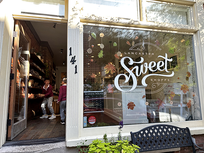 Fall leaves dance across the window display, nature's confetti celebrating what awaits inside this sweet sanctuary.