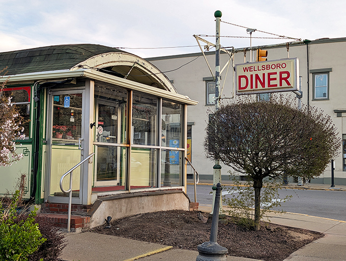 That classic "DINER" sign might as well say "COMFORT FOOD AHEAD" &ndash; the barrel-roofed entrance promises an authentic slice of Americana waiting inside.