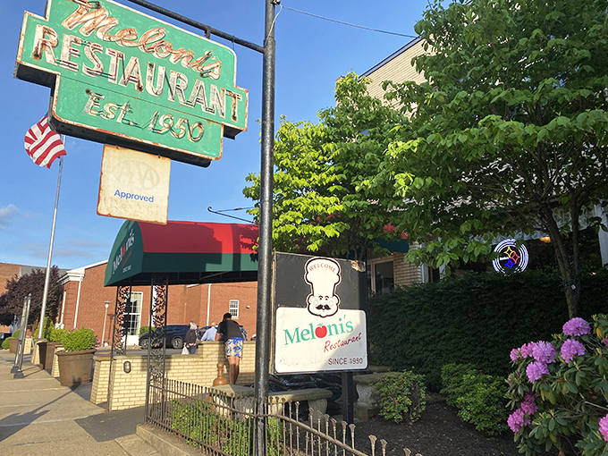 The iconic green sign at Meloni's has been guiding hungry Pennsylvanians to Italian comfort food since 1950, standing like a beacon of culinary tradition in Uniontown.