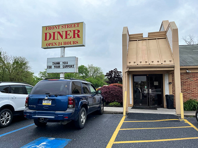 The iconic Front Street Diner sign promises "OPEN 24 HOURS" &ndash; a beacon of hope when hunger strikes at 3 AM and everywhere else has abandoned you.