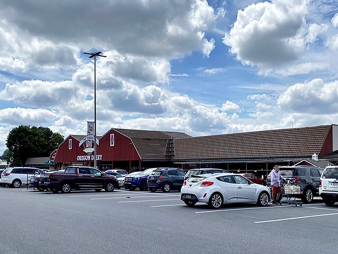 The iconic red barn exterior of Oregon Dairy stands proudly against Pennsylvania skies, promising farm-fresh delights within. A culinary beacon in Amish Country.