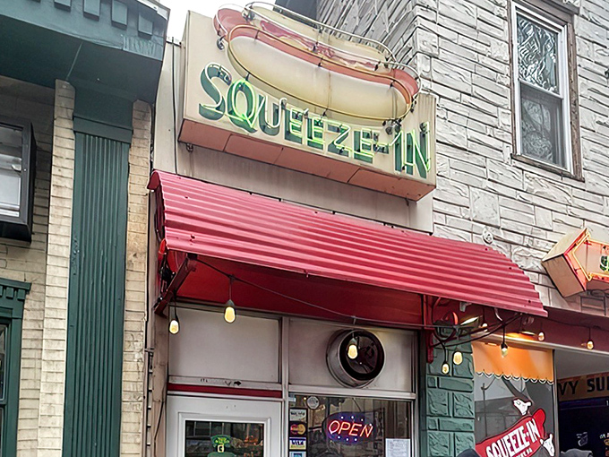 The iconic turquoise storefront beckons with its vintage neon arrow. At The Squeeze-In, the name isn't just clever marketing&mdash;it's a literal description.