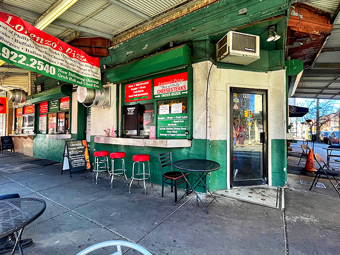 The iconic green exterior of Lorenzo's Pizza stands as a beacon of hope for the hungry at 9th and Christian in South Philly's Italian Market.