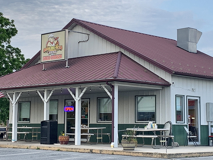 The white clapboard exterior with burgundy metal roof isn't trying to impress anyone&mdash;until you smell what's happening inside. Rural Pennsylvania BBQ perfection awaits.