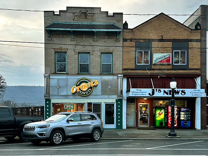 The unassuming storefront of Oram's Donuts stands like a beacon of sweetness on Beaver Falls' main drag, promising old-fashioned delights within those green-trimmed walls.