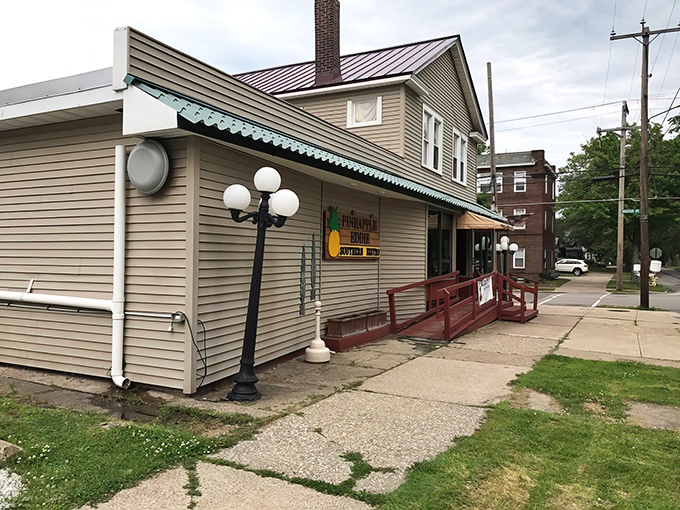 The unassuming exterior of Pineapple Eddie Southern Bistro proves once again that the best culinary treasures often hide behind modest facades. That turquoise awning signals deliciousness ahead!
