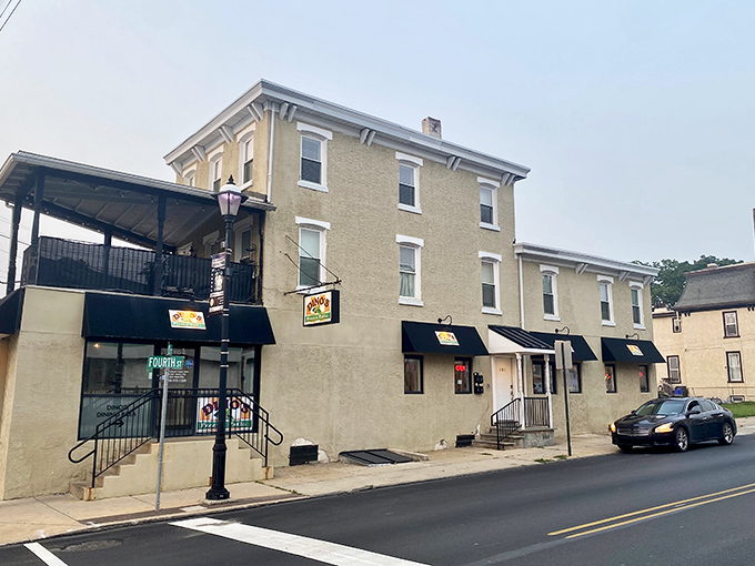 The unassuming yellow brick exterior of Dino's Pizza & Steaks stands like a culinary lighthouse in Bridgeport, beckoning hungry travelers from miles around.