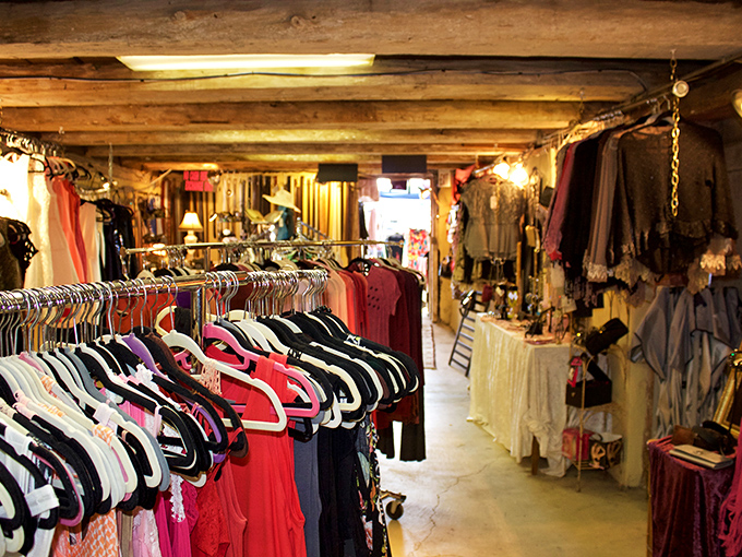 Vintage clothing heaven awaits in this rustic indoor section, where yesterday's fashion treasures hang like colorful promises of style reborn.