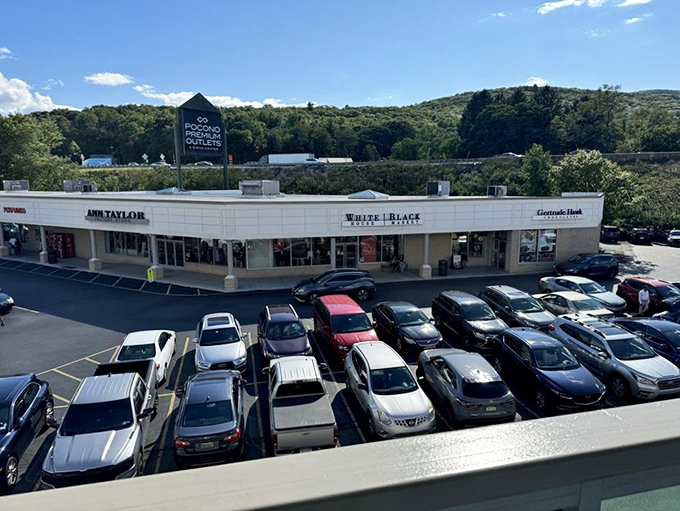 The Ann Taylor storefront stands ready for bargain hunters, with the iconic Pocono Premium Outlets sign perched above like a retail North Star.