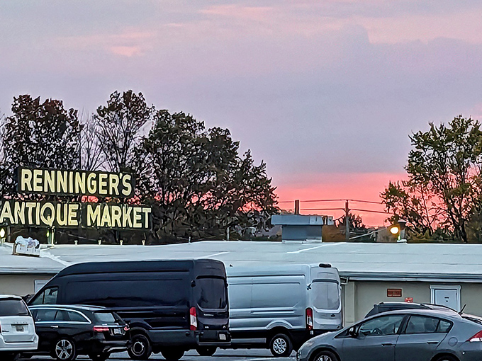 The iconic Renninger's sign glows against a Pennsylvania sunset, beckoning treasure hunters like a Vegas marquee for the vintage-obsessed.