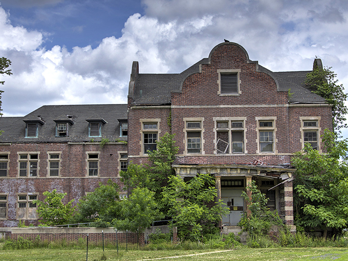 Time stands still in this eerie patient room, where peeling walls and weathered wooden doors whisper stories of a bygone institutional era.
