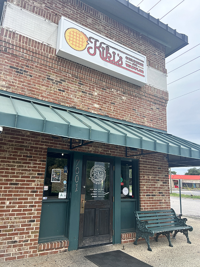 The brick fortress of flavor that houses Kiki's Chicken and Waffles stands unassumingly on Parklane Road, its green awning beckoning hungry travelers like a culinary lighthouse.