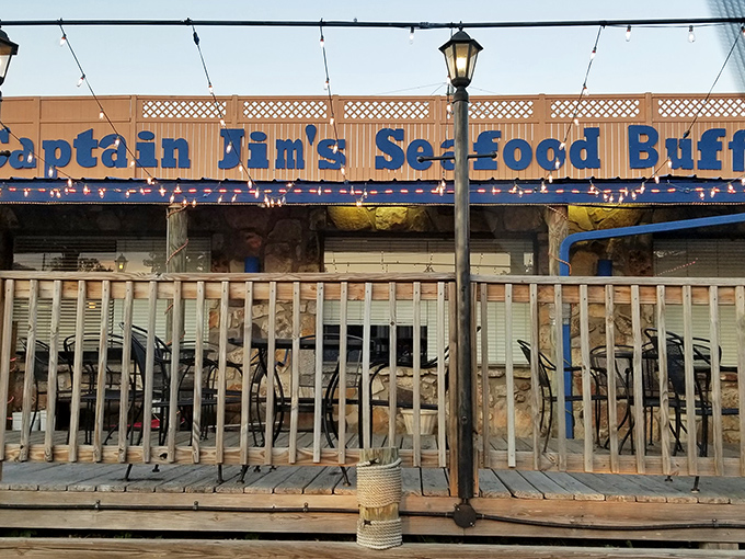 String lights and a vintage lamp post frame the entrance, where the blue lettering promises seafood adventures that'll make you forget you're hundreds of miles from any ocean.