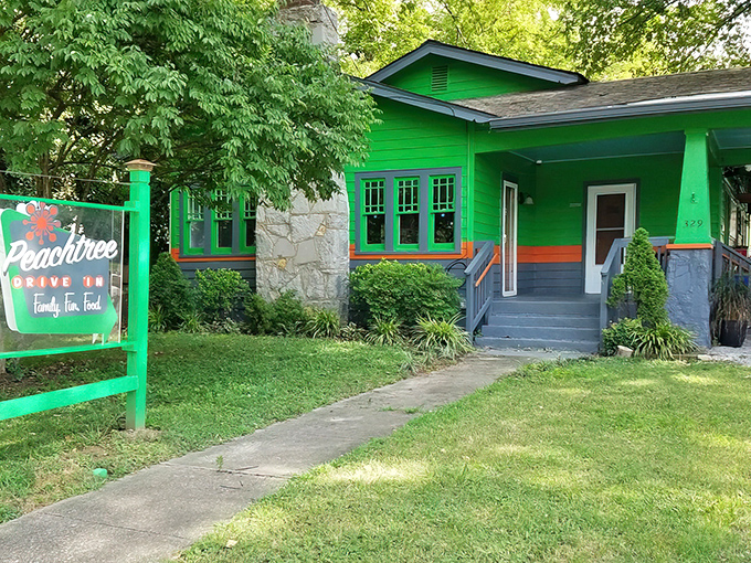 The little green house that could! Peachtree Neighborhood Grill's vibrant exterior and picnic tables invite you to slow down and savor Nashville's hidden culinary gem.