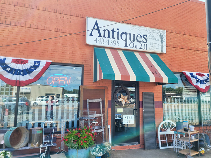 The cheerful orange facade of Antiques On 231 stands like a beacon for treasure hunters, complete with patriotic bunting that practically screams "Americana inside!"
