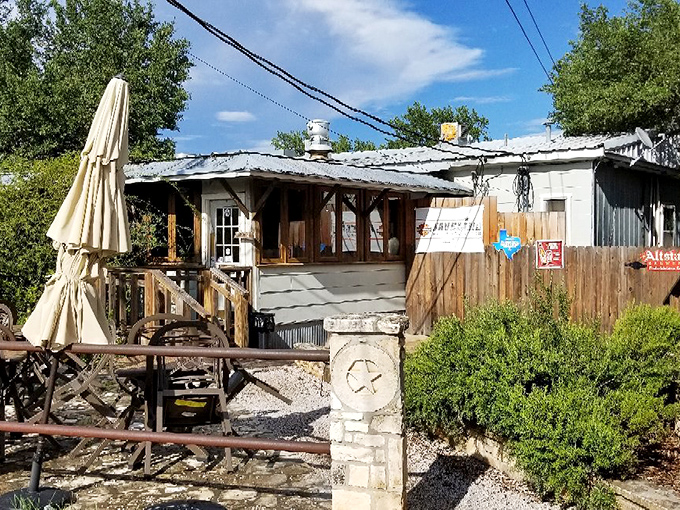 The promised land of patty perfection beckons with its umbrellas and wooden deck, where pilgrims gather for burger enlightenment in the Texas Hill Country.