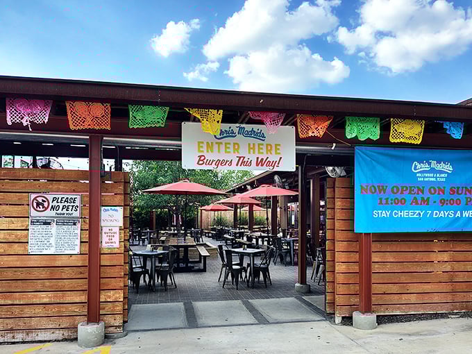 Welcome to burger paradise! The colorful papel picado banners above Chris Madrid's entrance are like festive flags signaling the cheese-laden treasures that await inside.