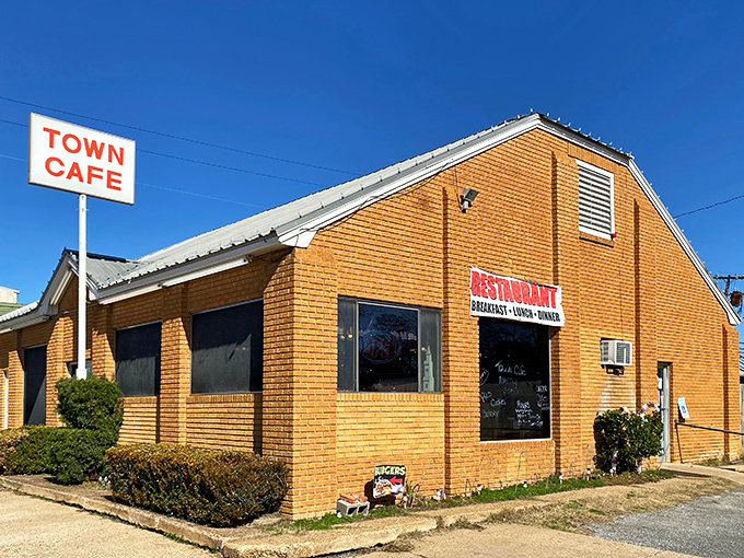 The iconic orange-brick exterior of Town Cafe stands proudly against the Texas sky, a beacon of comfort food that's been drawing hungry travelers off I-45 for generations.