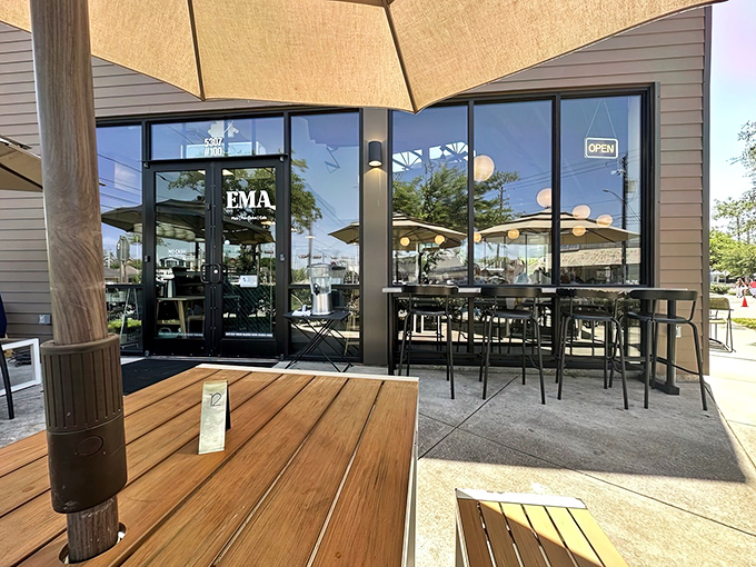 The modern storefront beckons with warm globe lights and a sleek design. Like finding a secret doorway to flavor paradise in suburban Houston.