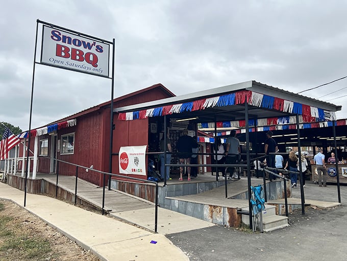 The unassuming red building with patriotic bunting doesn't scream "barbecue legend," but the line of eager pilgrims tells the real story.