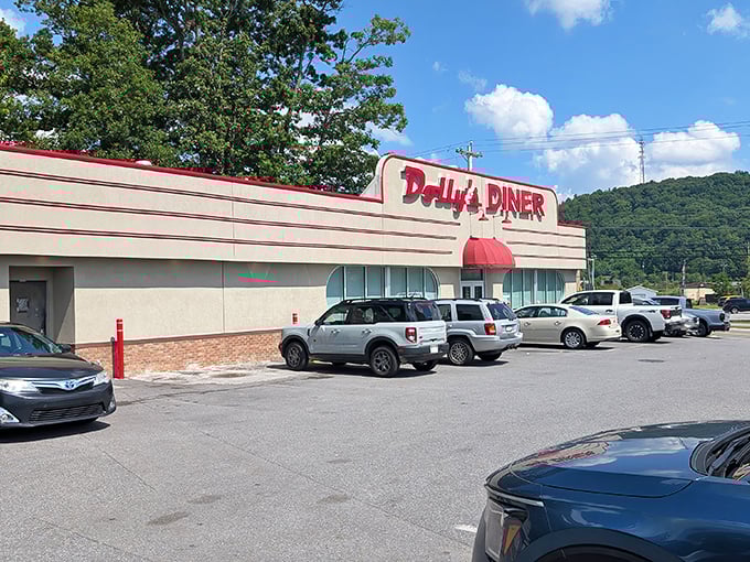 The classic streamlined exterior of Dolly's Diner stands proudly against West Virginia's rolling hills, like a time capsule of American dining history waiting to be opened.