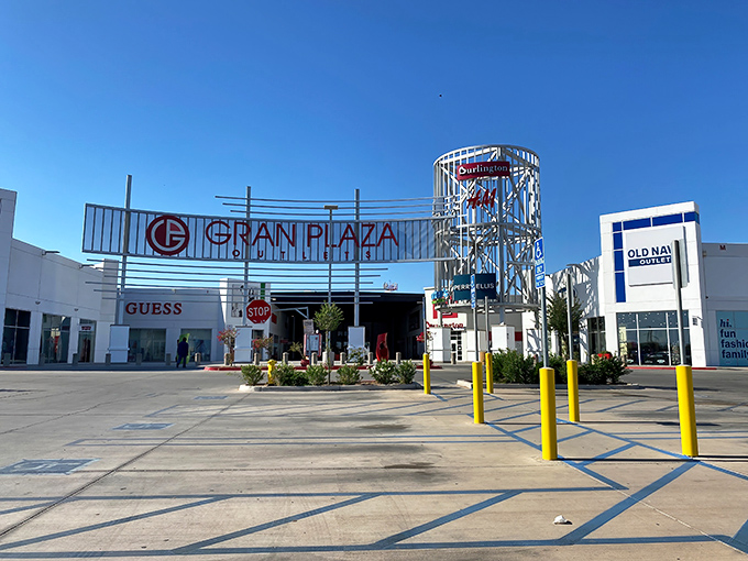 The iconic entrance to Gran Plaza Outlets stands like a retail oasis in the desert, where your wallet gets a vacation while your shopping bags get a workout.