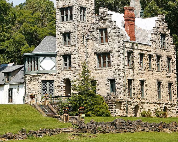 The limestone exterior of Piatt Castle Mac-A-Cheek features distinctive red-trimmed windows and dormers that make you wonder if you've accidentally wandered into a European fairy tale.