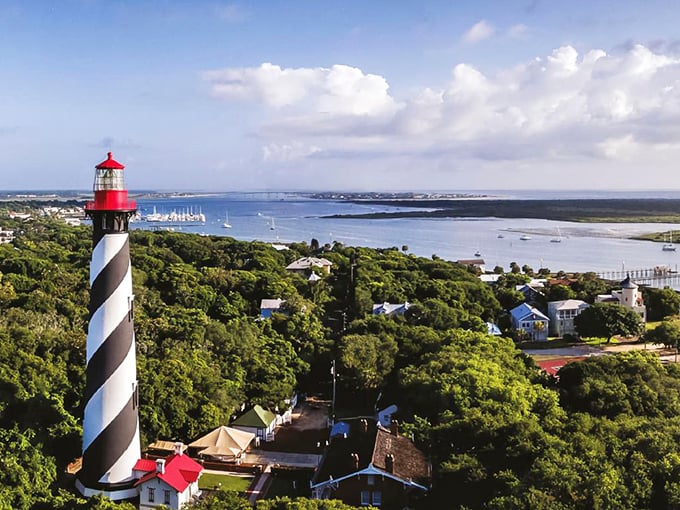 The iconic black and white spiral of St. Augustine Lighthouse stands sentinel over Anastasia Island, a postcard-perfect scene that's been guiding mariners since 1874.