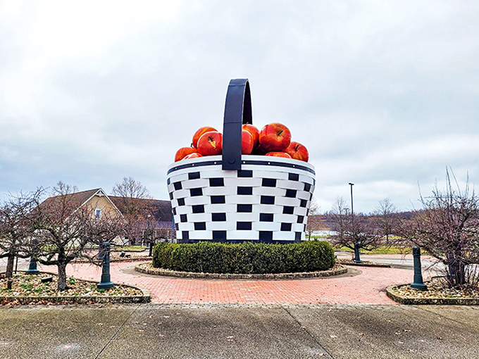 The World's Largest Apple Basket stands proudly against an overcast Ohio sky, proving that sometimes the best roadside attractions are exactly what they claim to be.