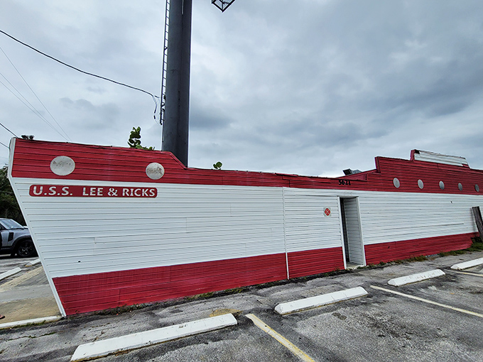 The U.S.S. Lee & Rick's sails proudly on land, its distinctive red and white boat-shaped exterior promising seafood treasures within. No pretension, just delicious anticipation.