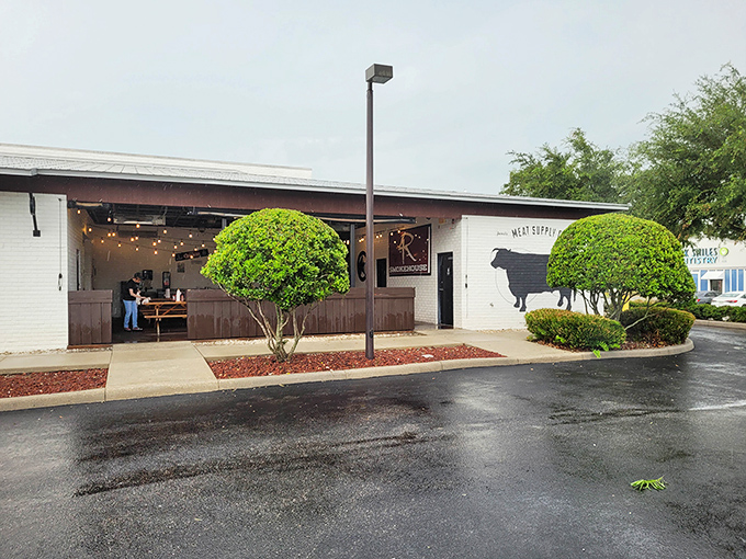 The white brick exterior of 4 Rivers Smokehouse promises barbecue nirvana, with a silhouette of a cow that seems to say, "You're welcome for what's about to happen to your taste buds."