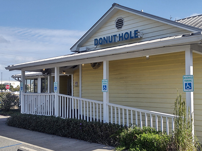 The cheerful yellow exterior of Donut Hole beckons like a sunrise, promising sweet beginnings to your day in Santa Rosa Beach.