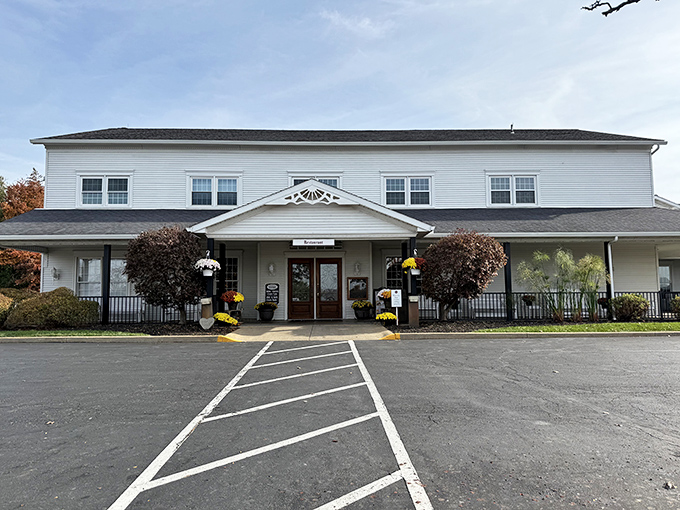 The Amish Door's welcoming facade stands ready for hungry travelers. Those mums aren't just decoration—they're a promise of seasonal attention to detail inside.