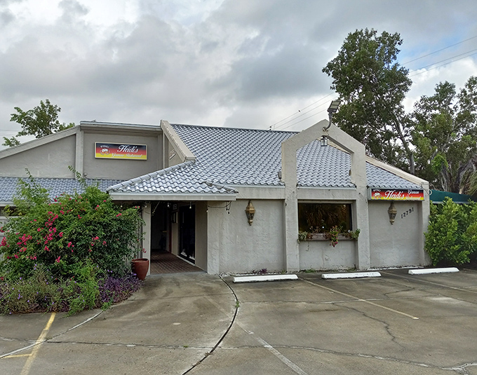 A slice of Bavaria hiding in plain sight! Heidi's distinctive blue-tiled roof and stucco exterior stands out among Florida's palm trees like lederhosen at a beach party.