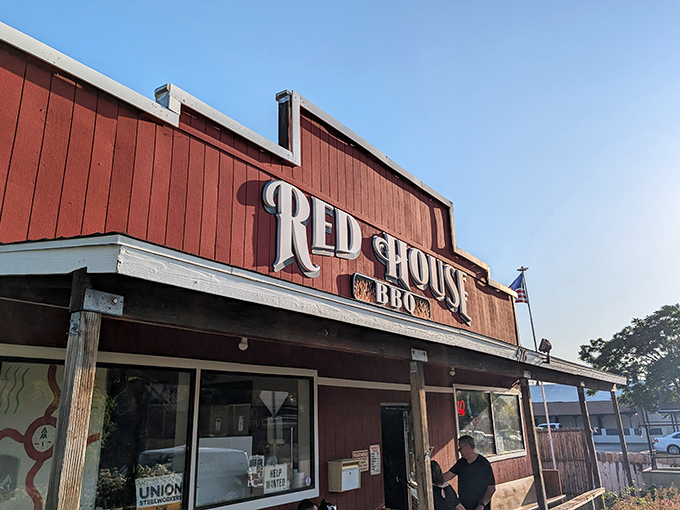 From another angle, the rustic charm of Red House BBQ's facade hints at the no-nonsense, all-flavor approach to smoked meats waiting inside.