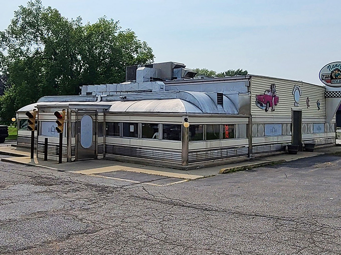 The classic stainless steel exterior of Nancy's Main Street Diner gleams like a time machine to the golden age of American roadside dining.