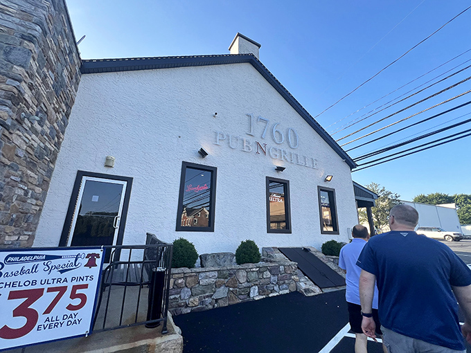 The white-washed exterior with stone accents glows invitingly at dusk, like a lighthouse for the hungry navigator seeking comfort food harbor.