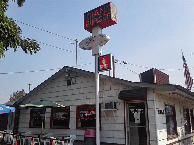 The white building with bold red lettering stands as a time capsule of American dining. No frills, just the promise of burger perfection.