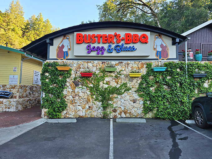 Stone walls draped with ivy frame the bold red "BUSTER'S BBQ" sign &ndash; a siren call to barbecue pilgrims in wine country's unexpected smoke sanctuary.