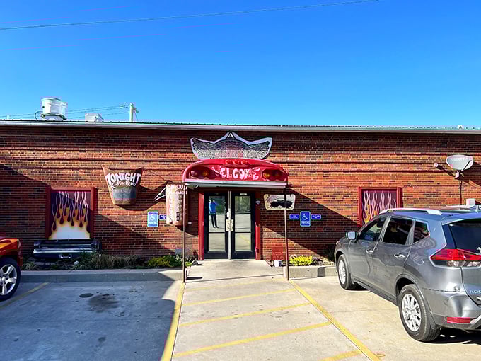 The unassuming brick exterior of A Little BBQ Joint hides culinary treasures within. Those flame-painted windows aren't just decoration&mdash;they're truth in advertising.