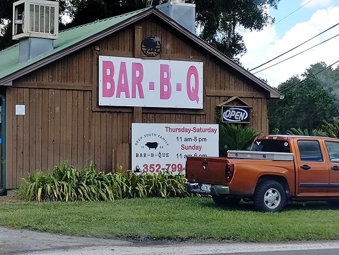 That pink "BAR-B-Q" sign might as well say "FOLLOW YOUR NOSE." No fancy facade needed when what's happening inside has smoke rings that could make a pitmaster weep.