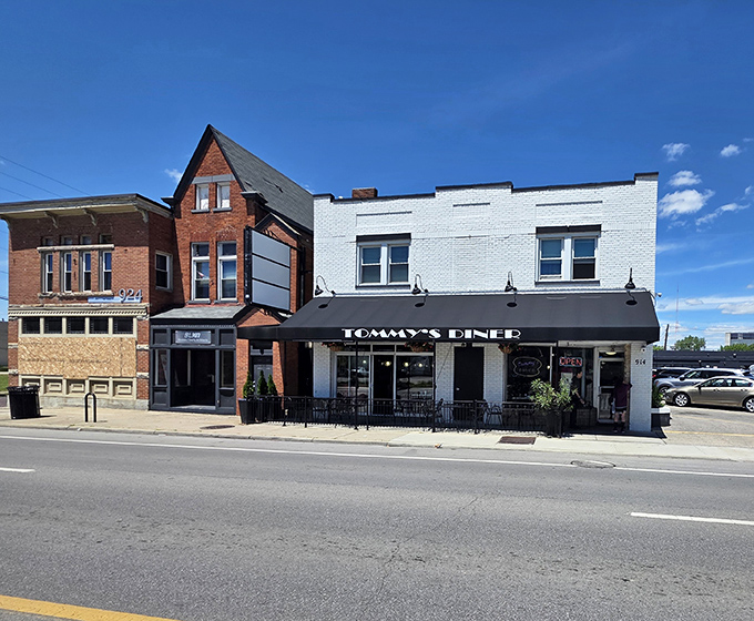 The iconic red arrow sign of Tommy's Diner stands like a retro beacon on West Broad Street, promising comfort food and nostalgia in equal measure.