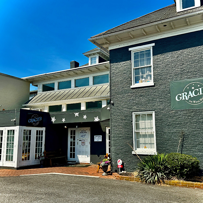 The stone facade of Gracie's On West Main stands proudly against a brilliant blue Pennsylvania sky, promising comfort food treasures within.