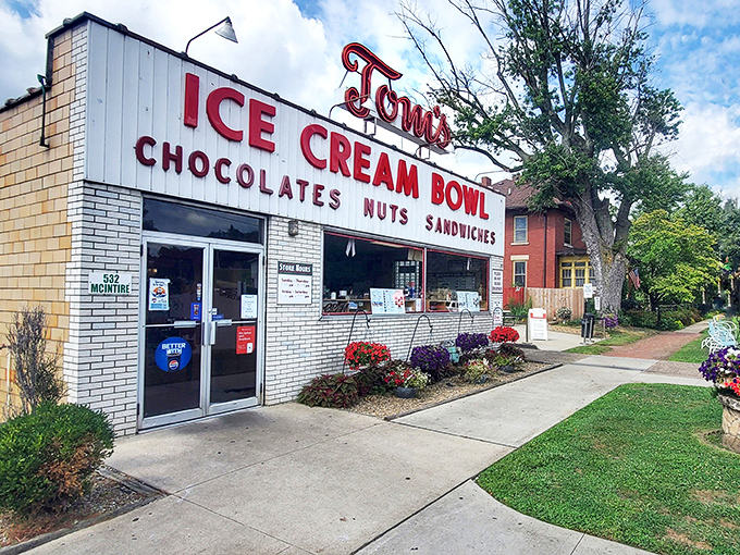 The iconic storefront beckons like a time machine disguised as an ice cream shop. Those neon letters have been guiding sweet-toothed pilgrims for generations.