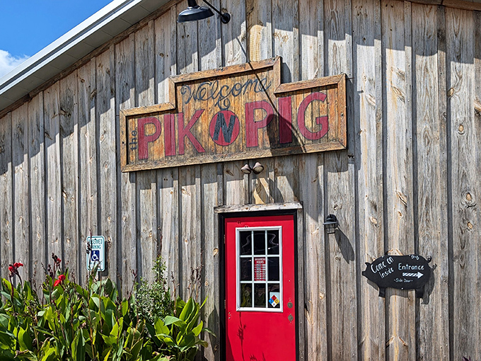 Rustic charm meets serious barbecue at Pik N Pig's weathered wooden exterior. That red door isn't just an entrance&mdash;it's a portal to smoke-infused happiness.