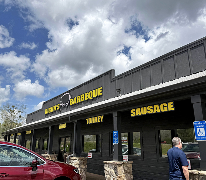 The unassuming exterior of Bigun's Barbeque stands like a beacon of smoky promise against the Georgia sky, its bold yellow signage a siren call to hungry travelers.